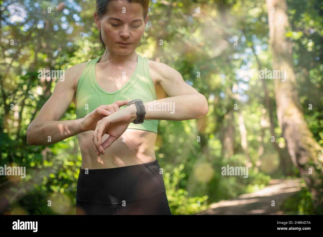 Athletic woman checking smartwatch hi-res stock photography and images ...