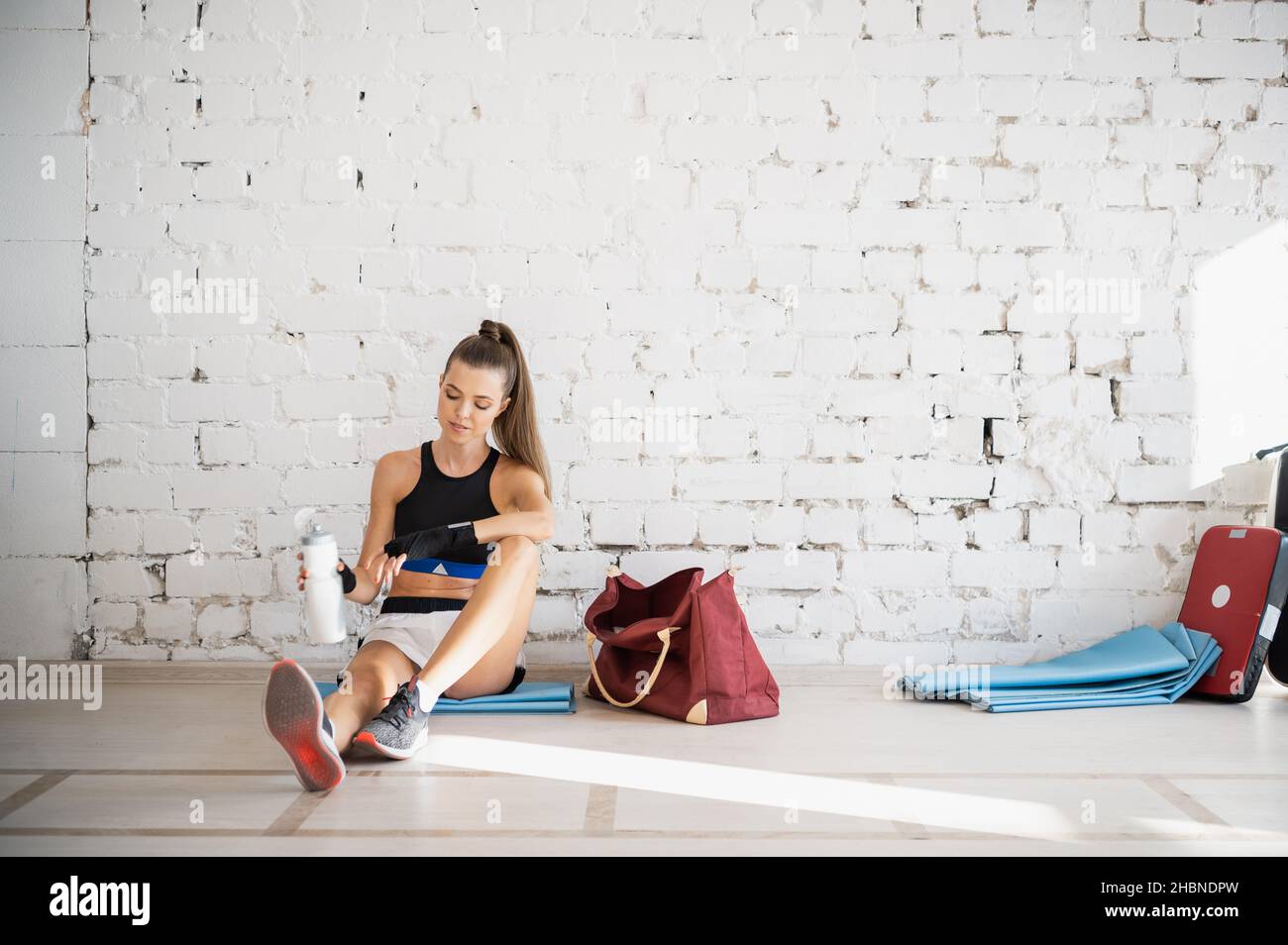 Female fighter exhausted after exercise feeling dehydration, drinks ...