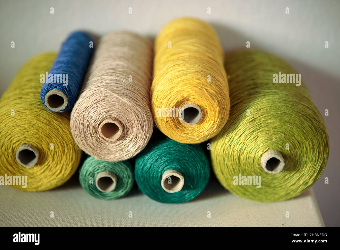 Set of cord in shades of green close-up. Retro style threads on spool ...