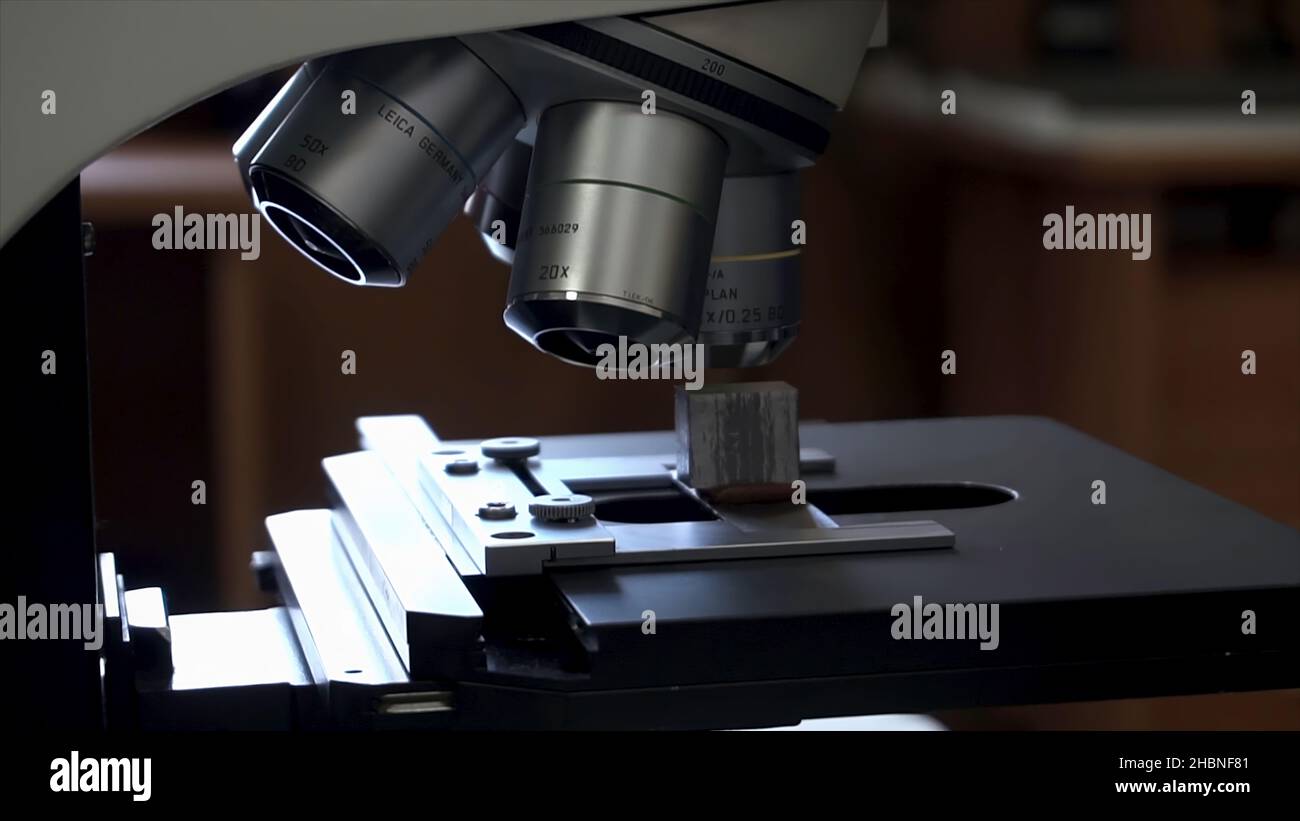 Close up for the microscope lens, science concept. Microscope standing on the table, scientific ...