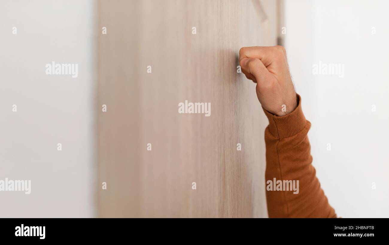 Male hand is knocking on wooden door hi-res stock photography and ...