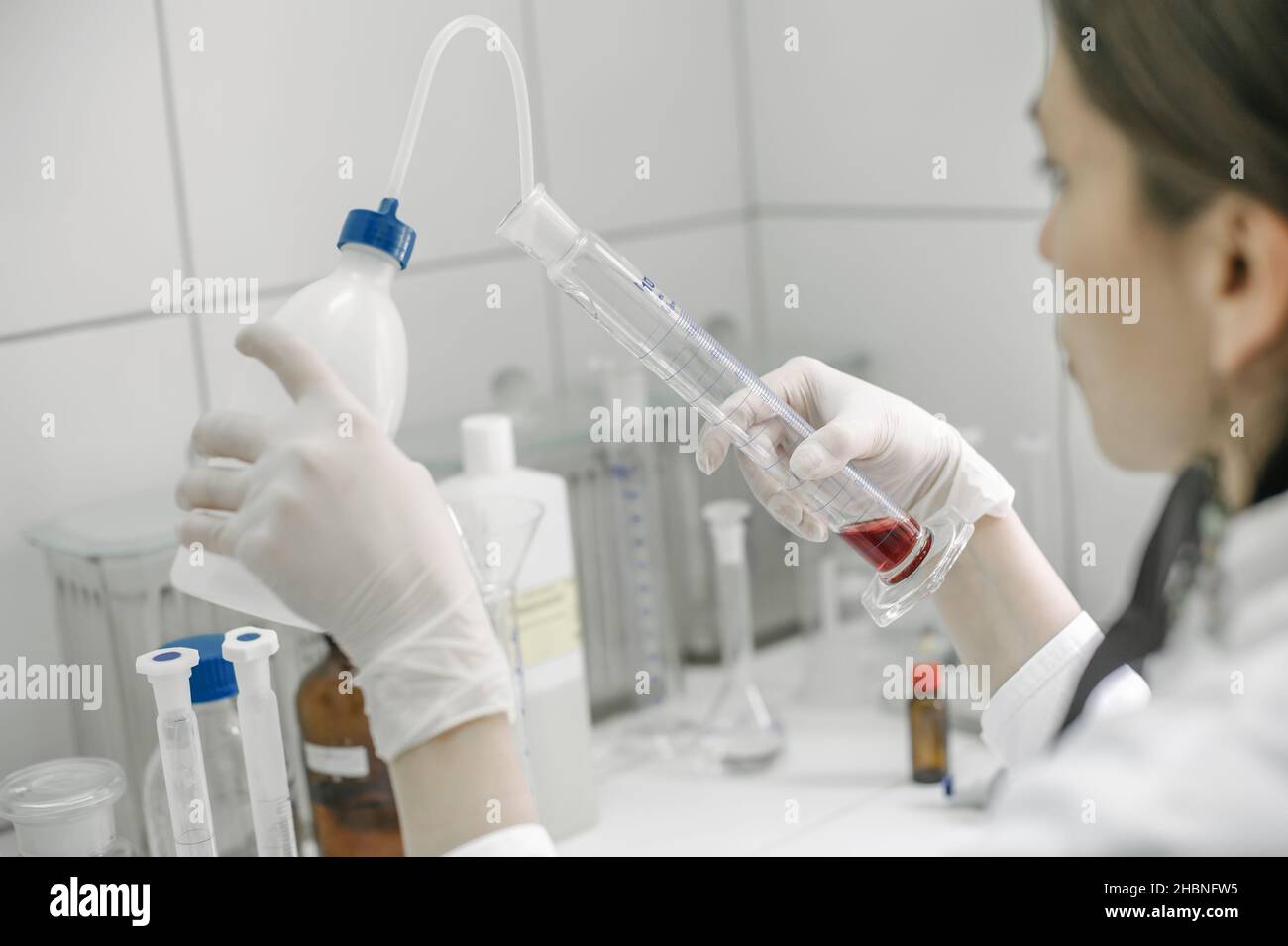 Female laboratory researcher performs tests in the medical or ...