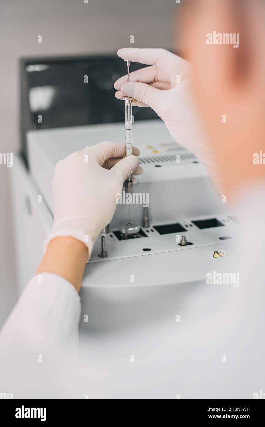 Portrait of female researcher doing research in a chemistry lab. Gas ...