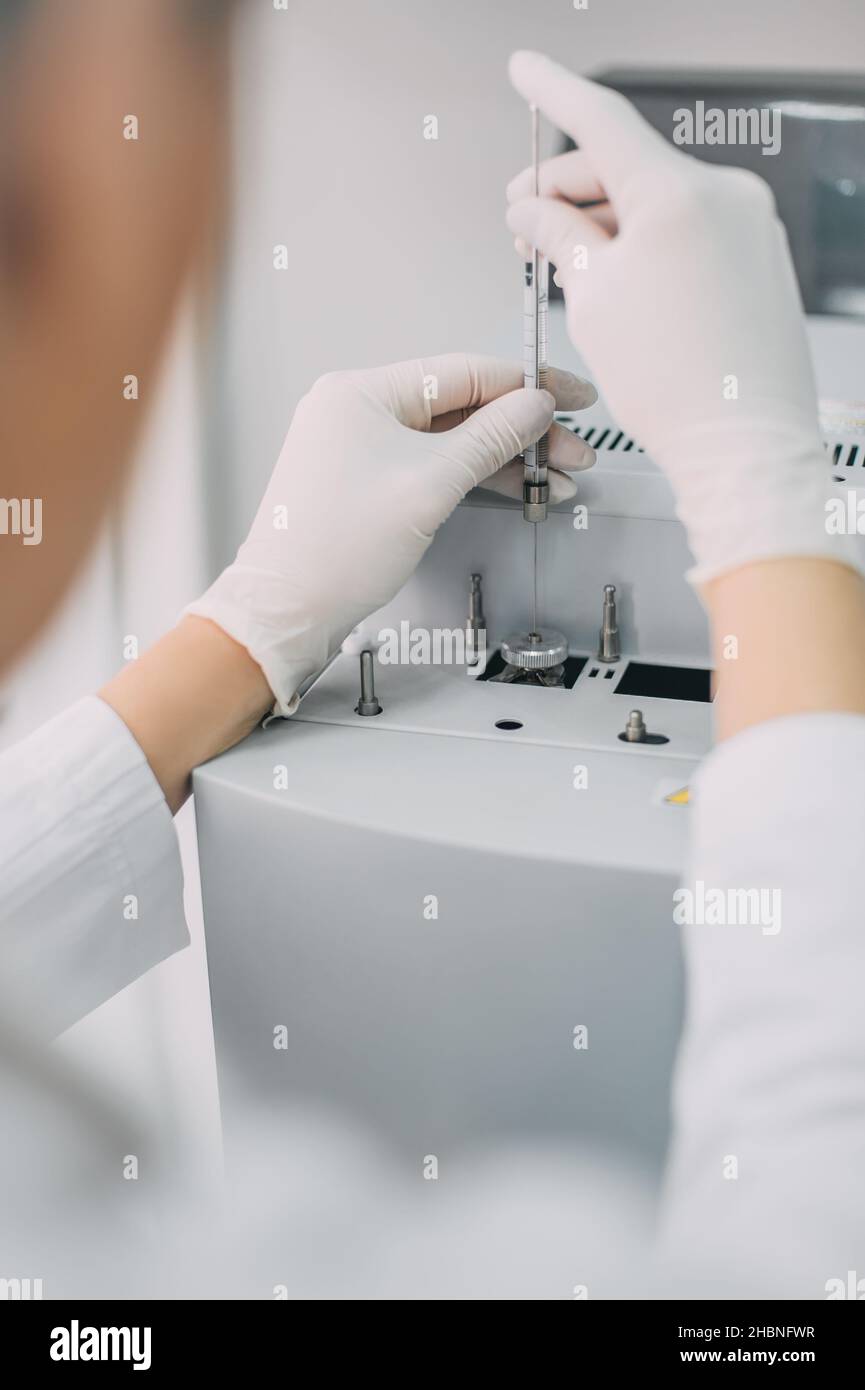 Portrait of female researcher doing research in a chemistry lab. Gas ...