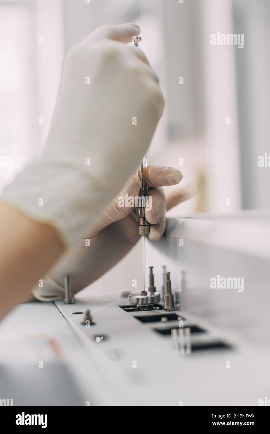 Portrait of female researcher doing research in a chemistry lab. Gas ...