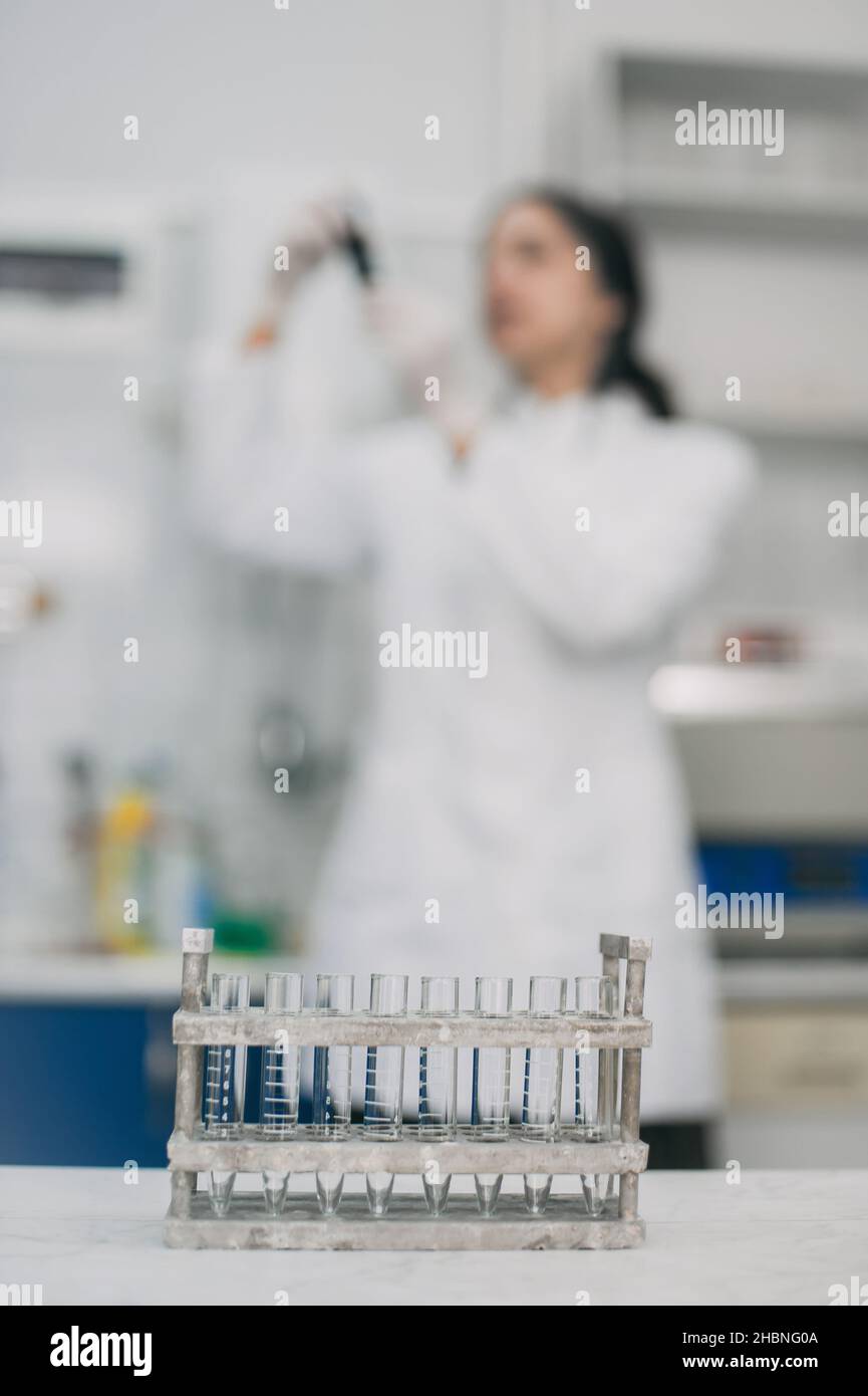 Medical laboratory scientists holding a test tube with sample in the ...