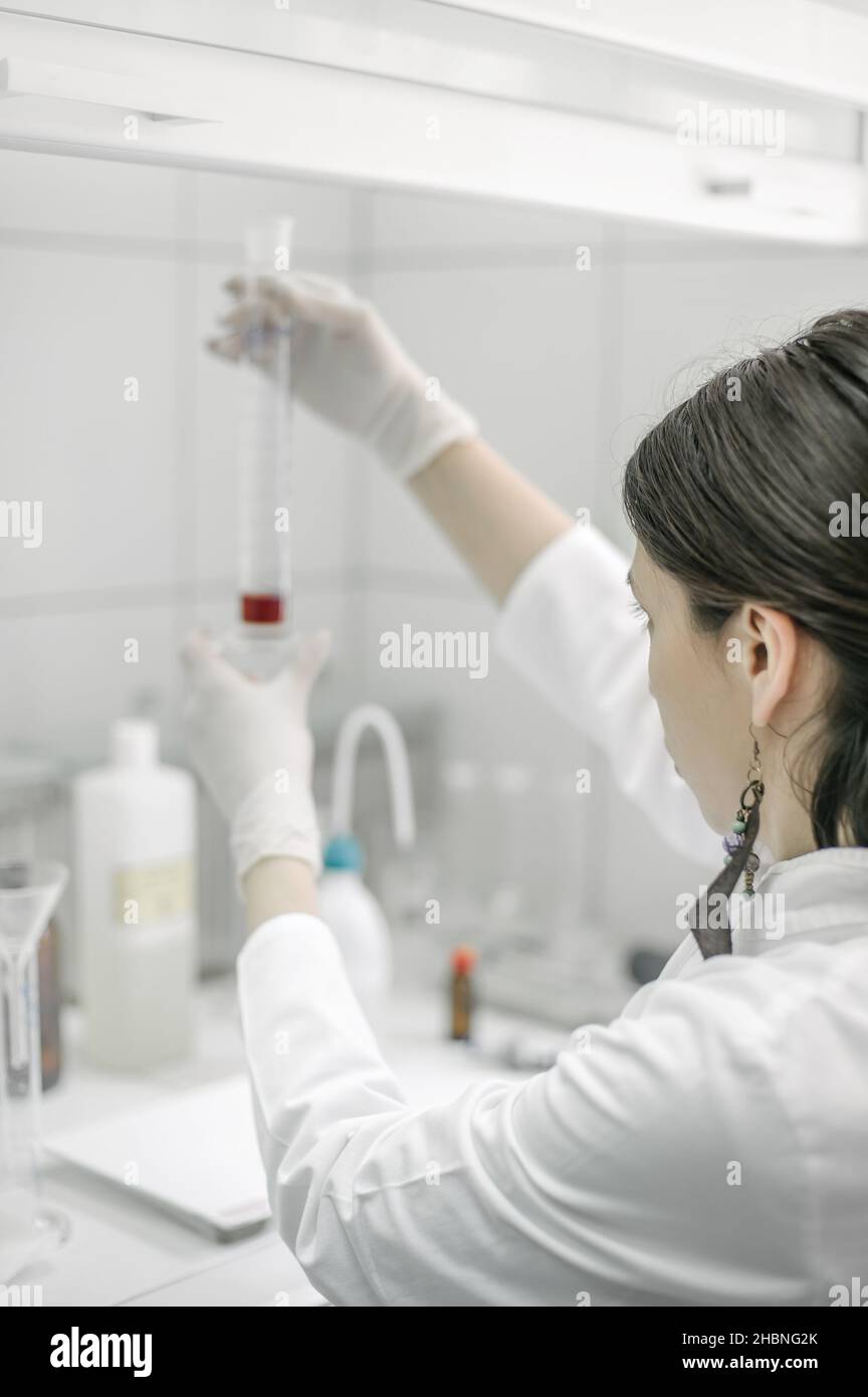 Medical laboratory scientists holding a test tube with sample in the ...
