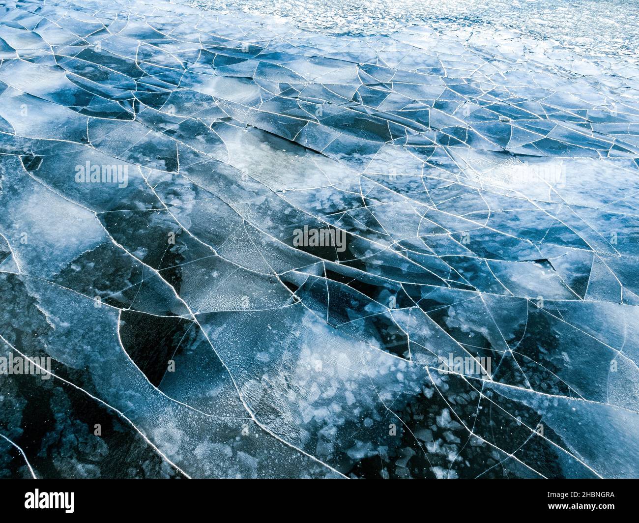 A closeup shot of cracked ice surface on a cold winter day Stock Photo ...