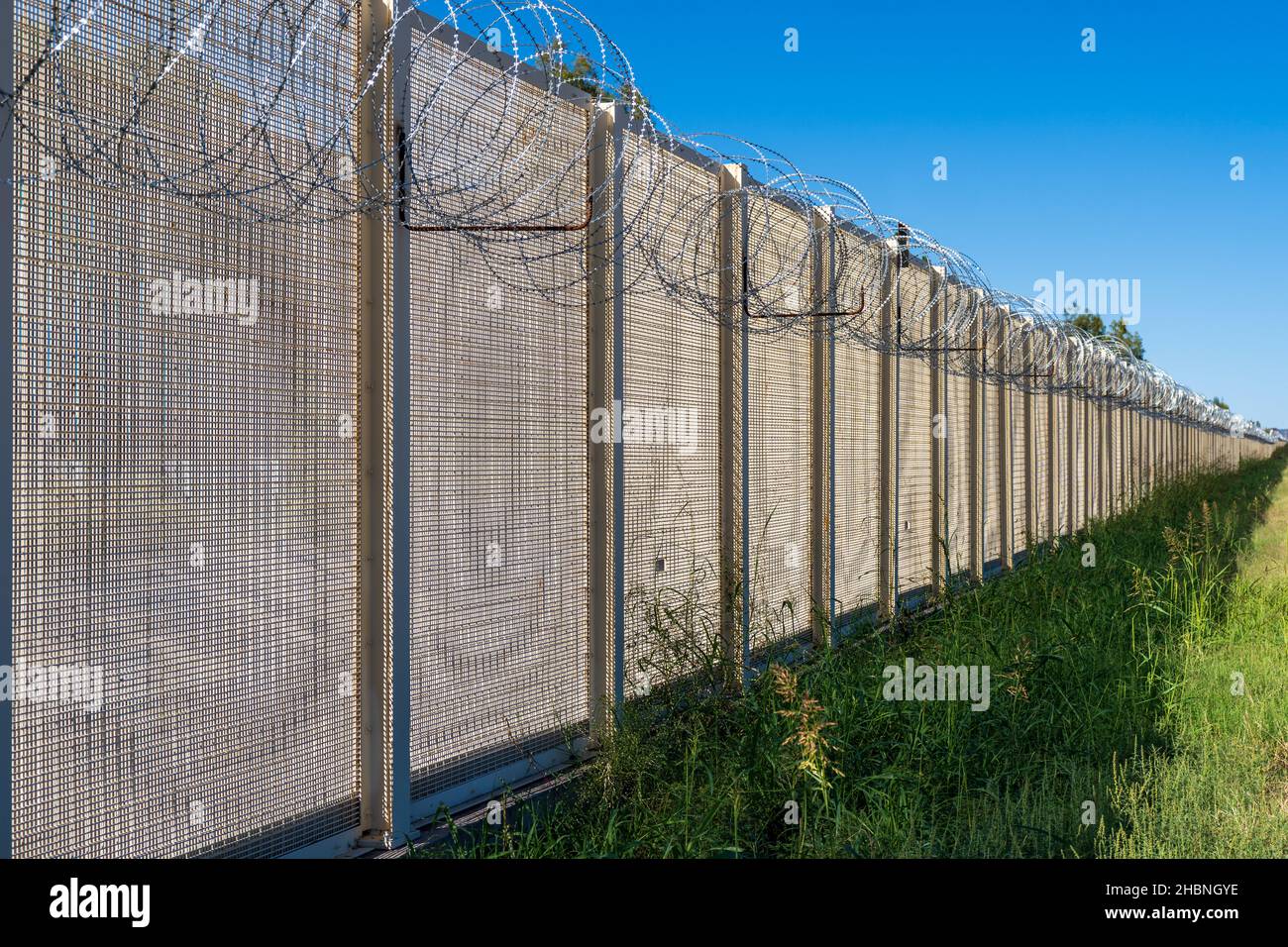 selective focus on international border fence with razor wire at the ...