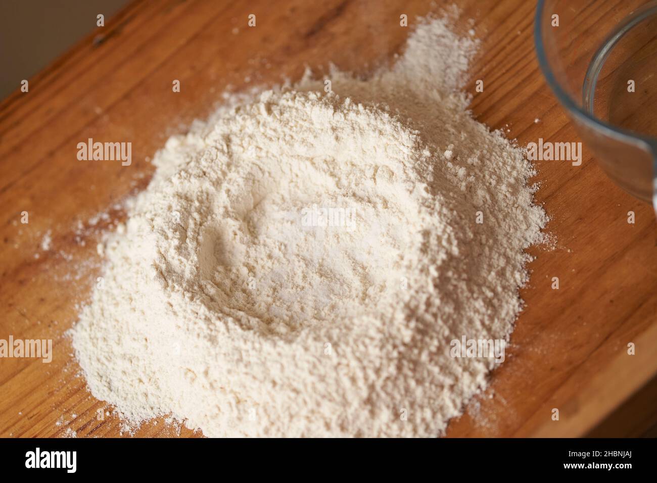 wheat flour volcano on the flour counter Stock Photo - Alamy