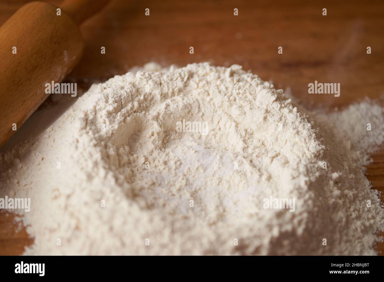 wheat flour volcano on the flour counter and rolling pin Stock Photo ...