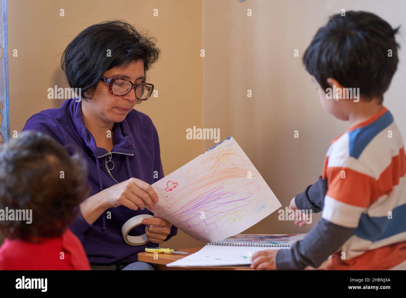 mother teaches her children while drawing Stock Photo - Alamy