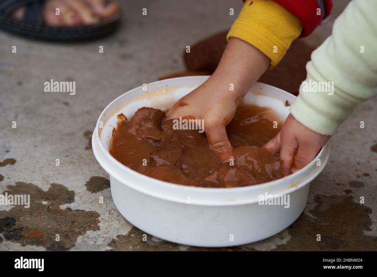 children's hands in a container molding clay Stock Photo - Alamy