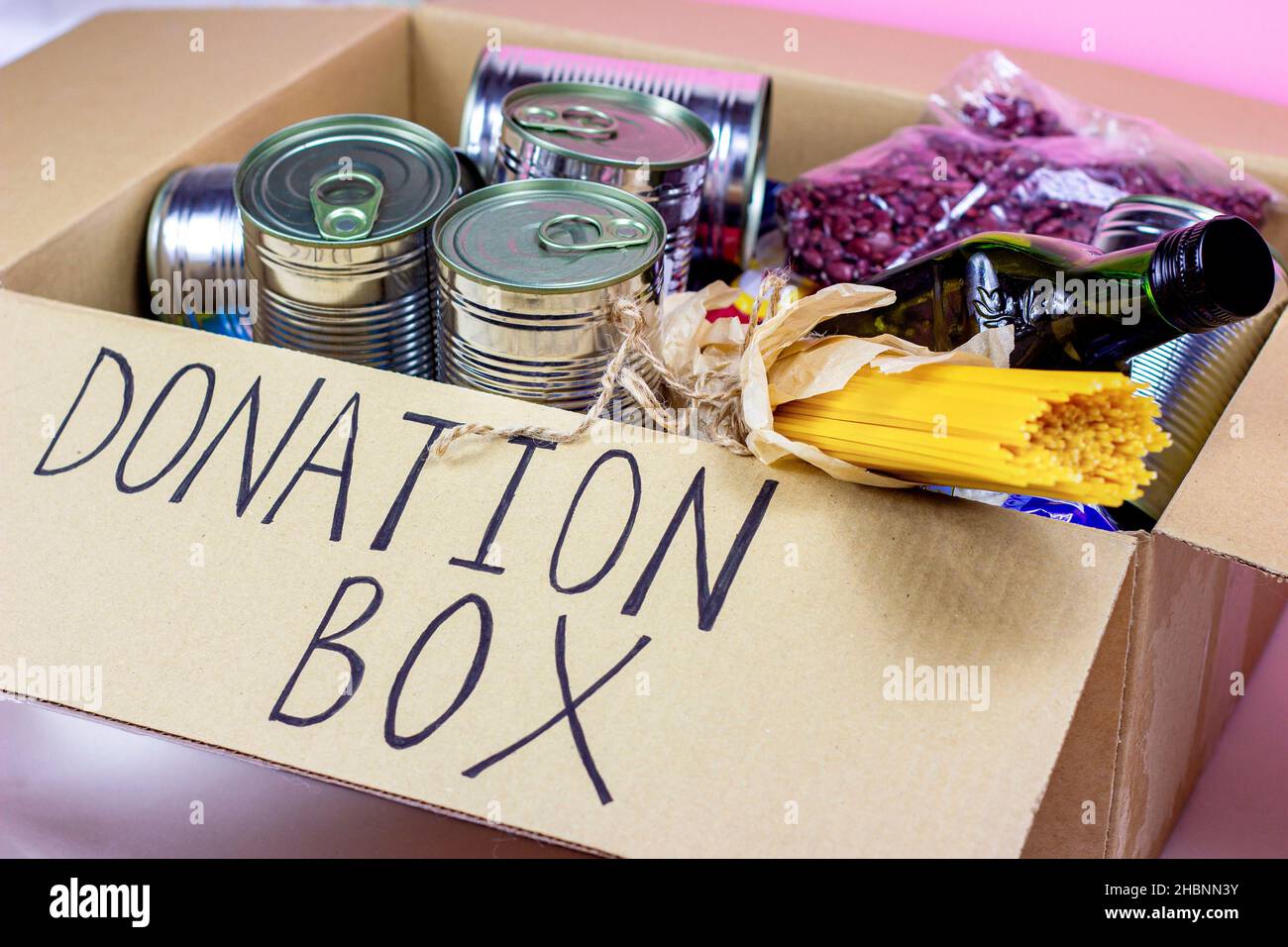Donation carton box with food (pasta, cans, beans and other ...