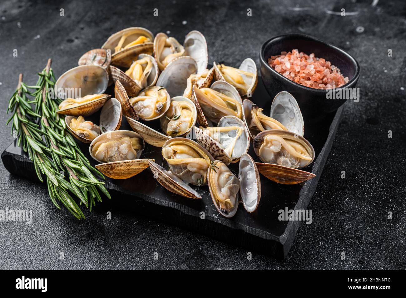 Steamed shellfish Clams with garlic and herbs. Black background. Top ...