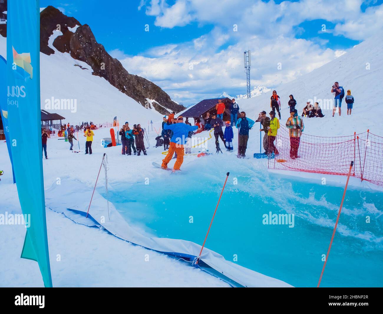 Russia, Sochi 11.05.2019. A guy on a snowboard crosses a pool of water ...