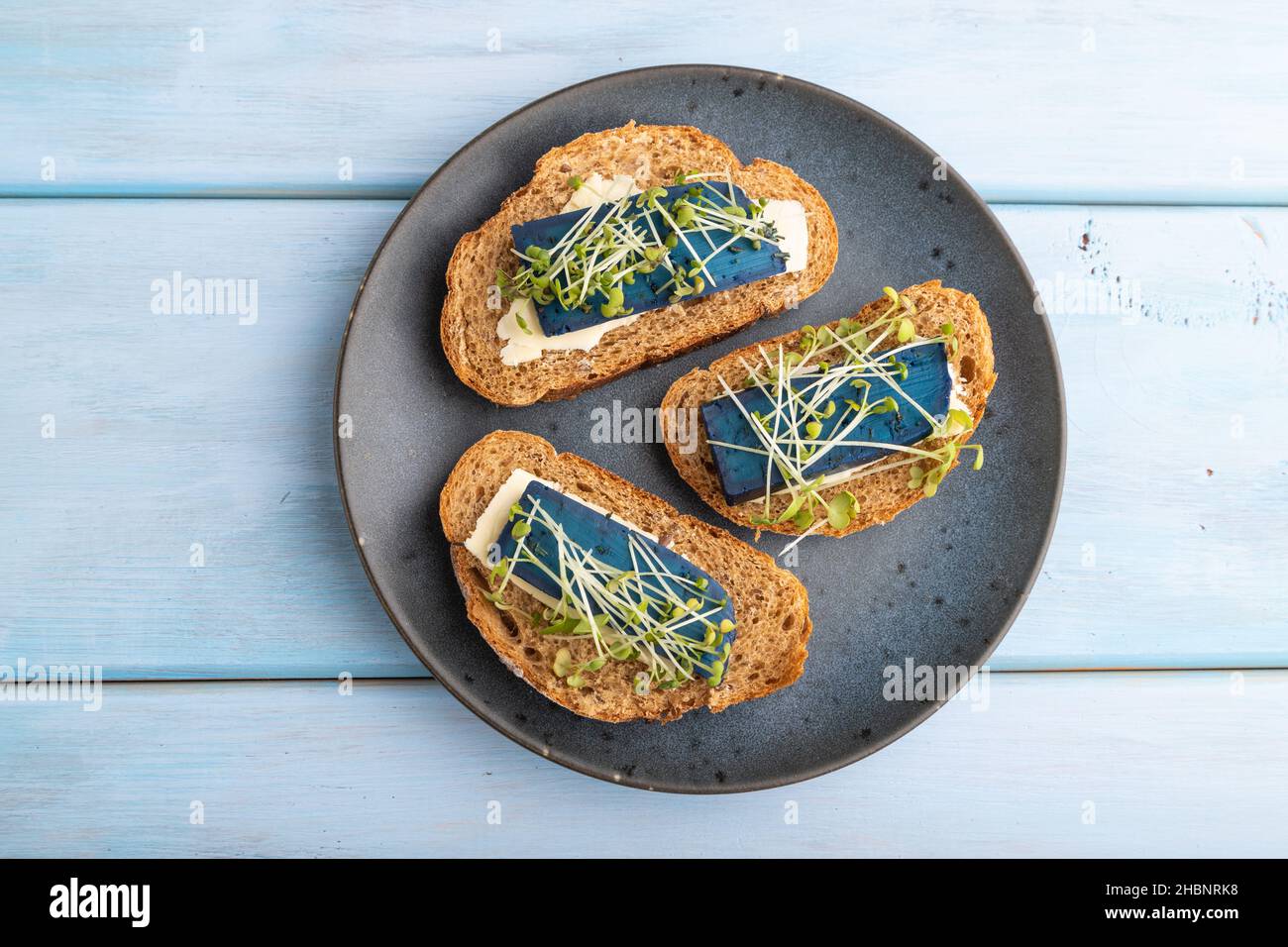 Bread sandwiches with blue lavender cheese and mustard microgreen on ...