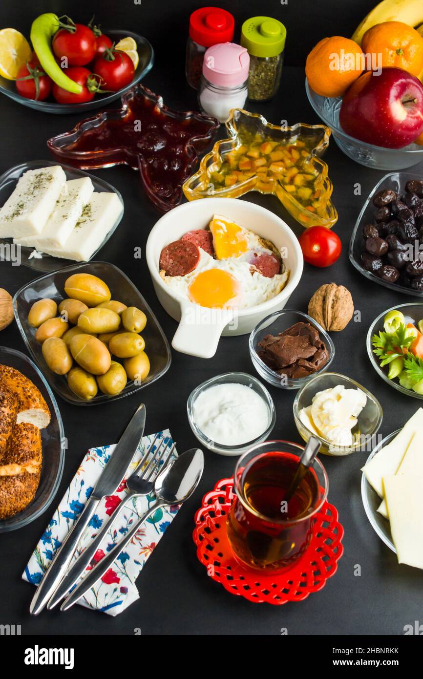 Traditional Turkish Breakfast on the black surface.Sausage and egg on ...