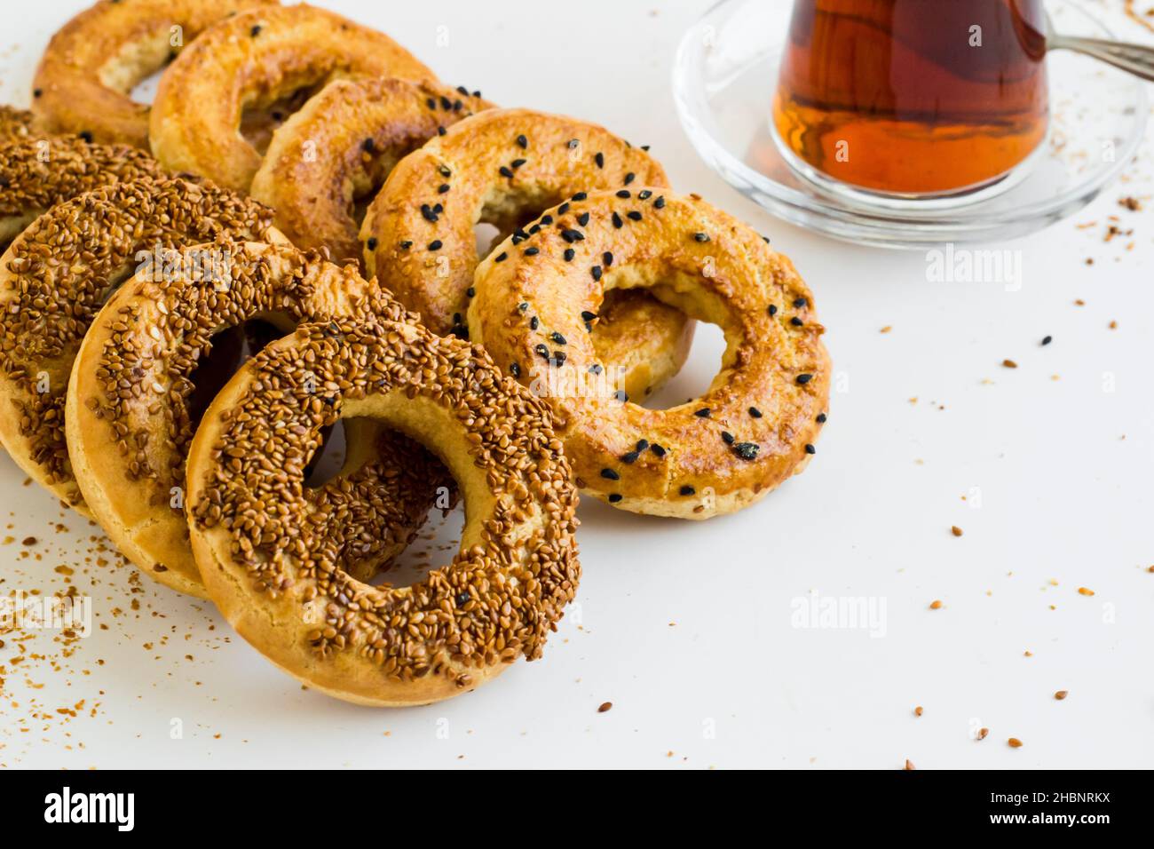Traditional Turkish Kandil Sesame Rings on white surface with tea Stock ...