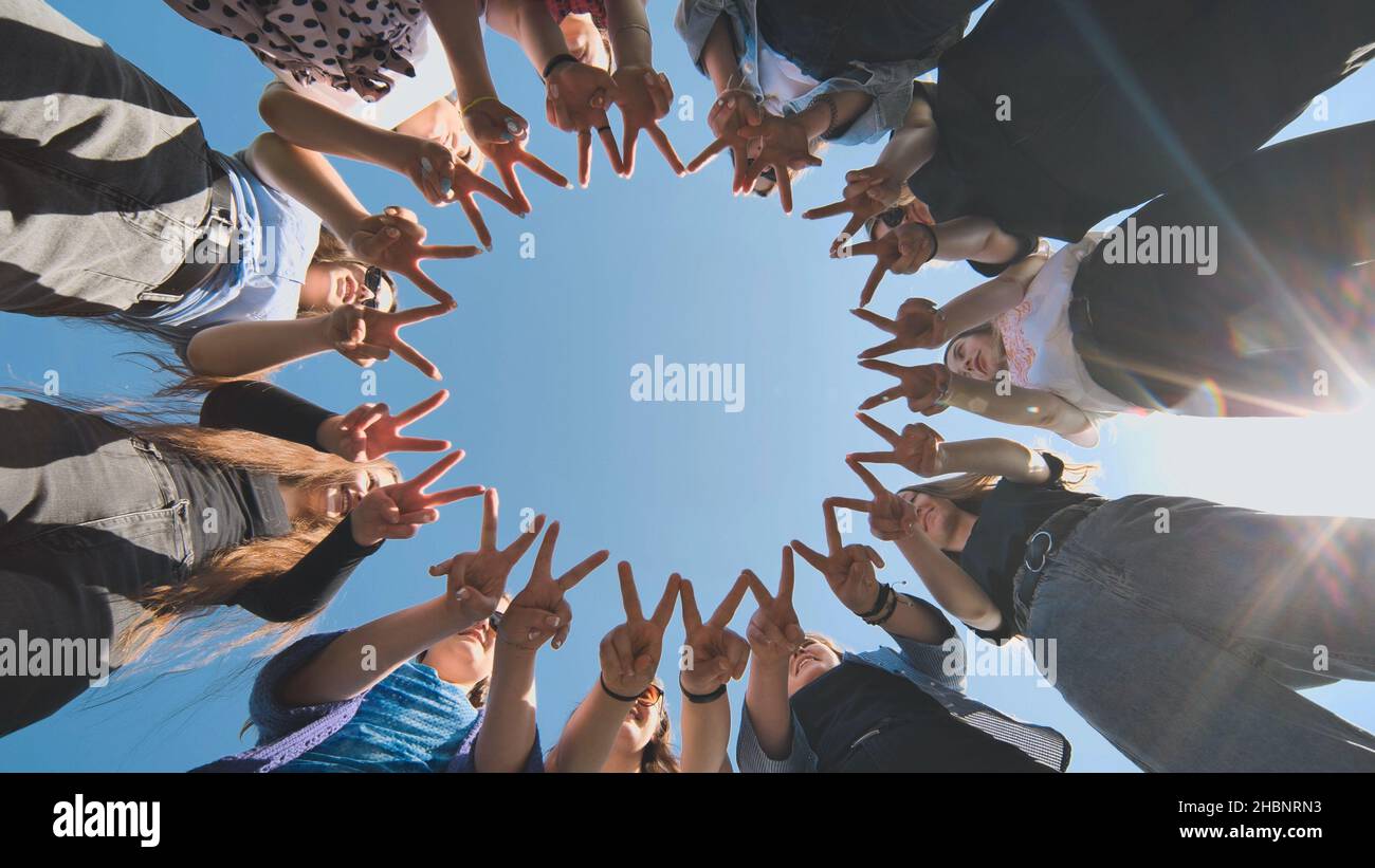 A group of girls makes a circle from their fingers Stock Photo - Alamy