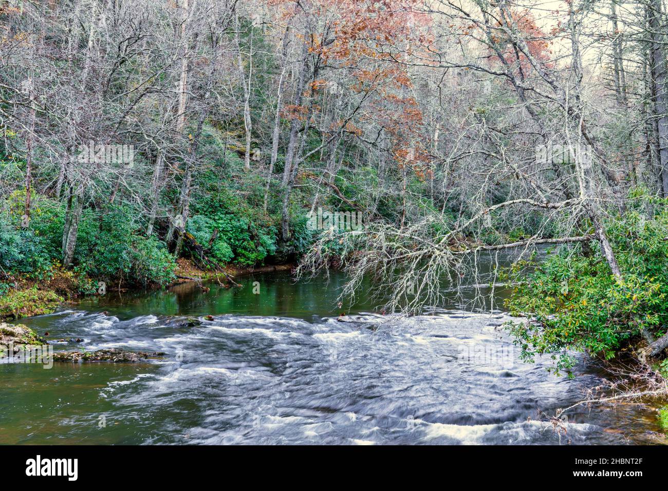 The Linville River flows rapidly over rocks by the Linville Falls ...