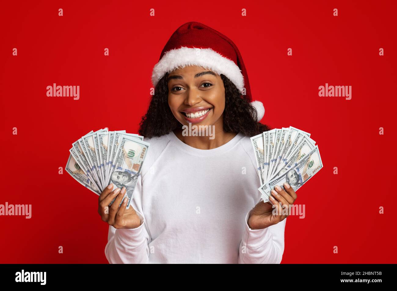 Happy young black lady holding a lot of cash Stock Photo - Alamy