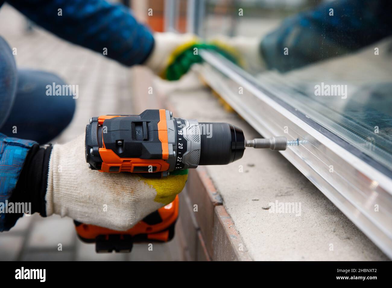 The wizard is engaged in installing windows. Repair work Stock Photo ...