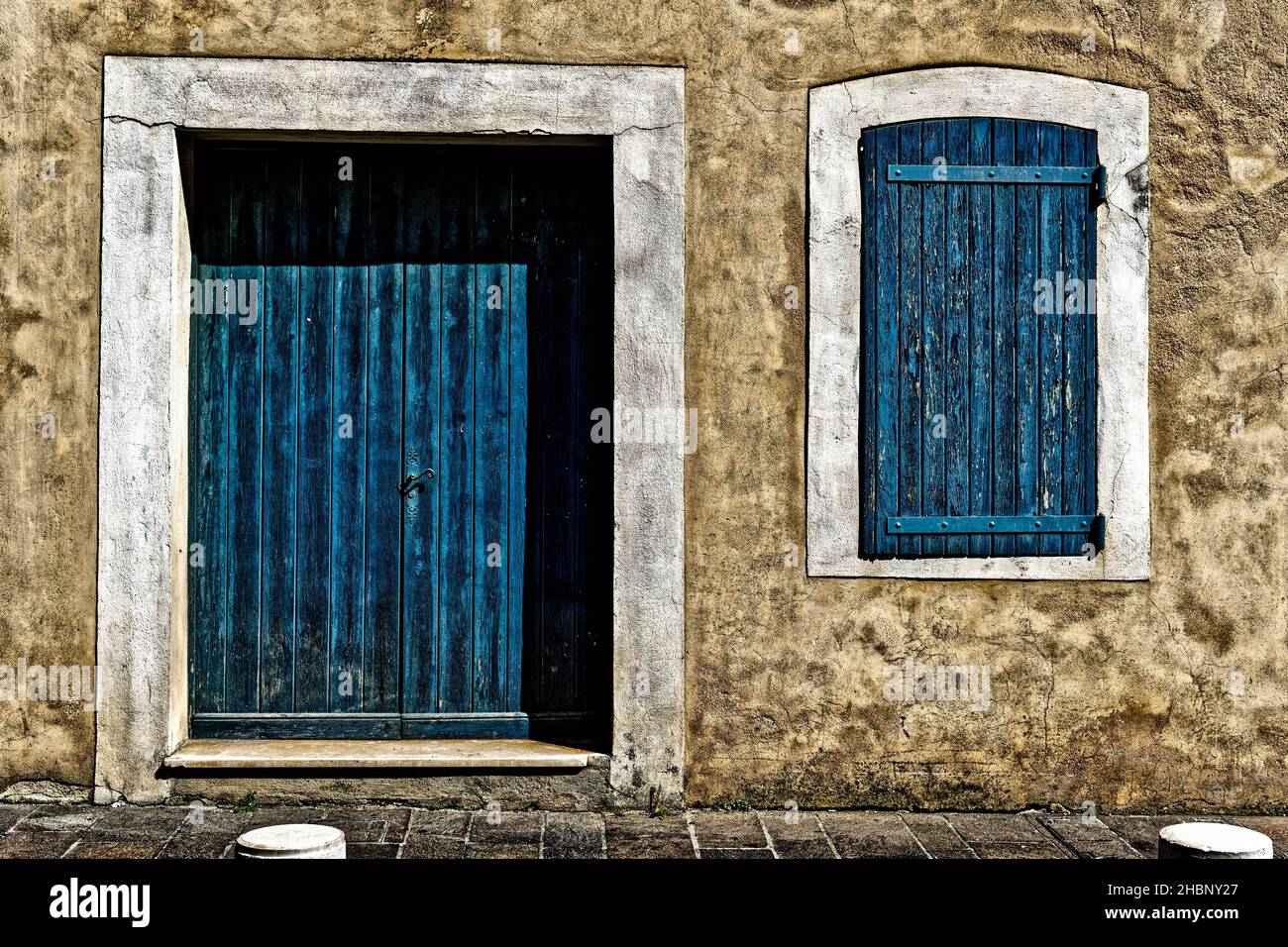 A beautiful stone building facade with blue wooden window and door in ...