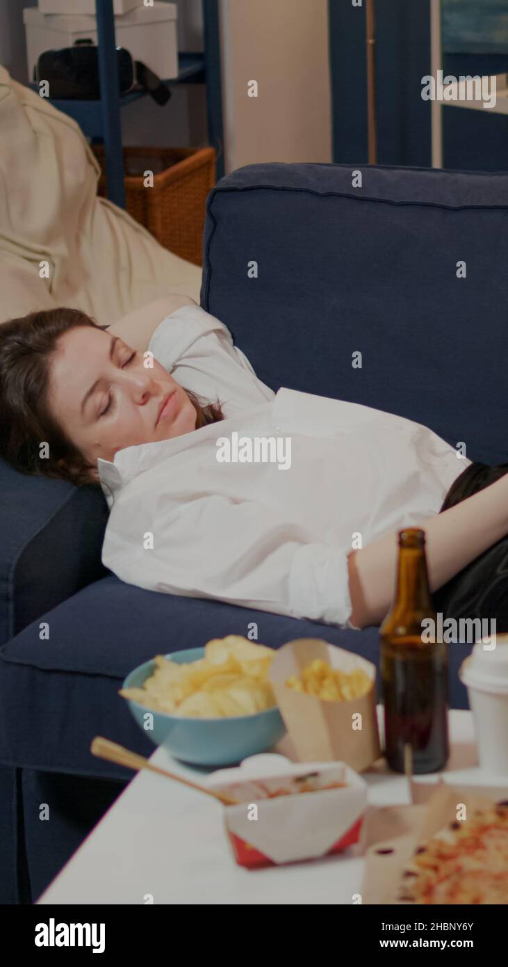Woman laying on couch eating hi-res stock photography and images - Alamy