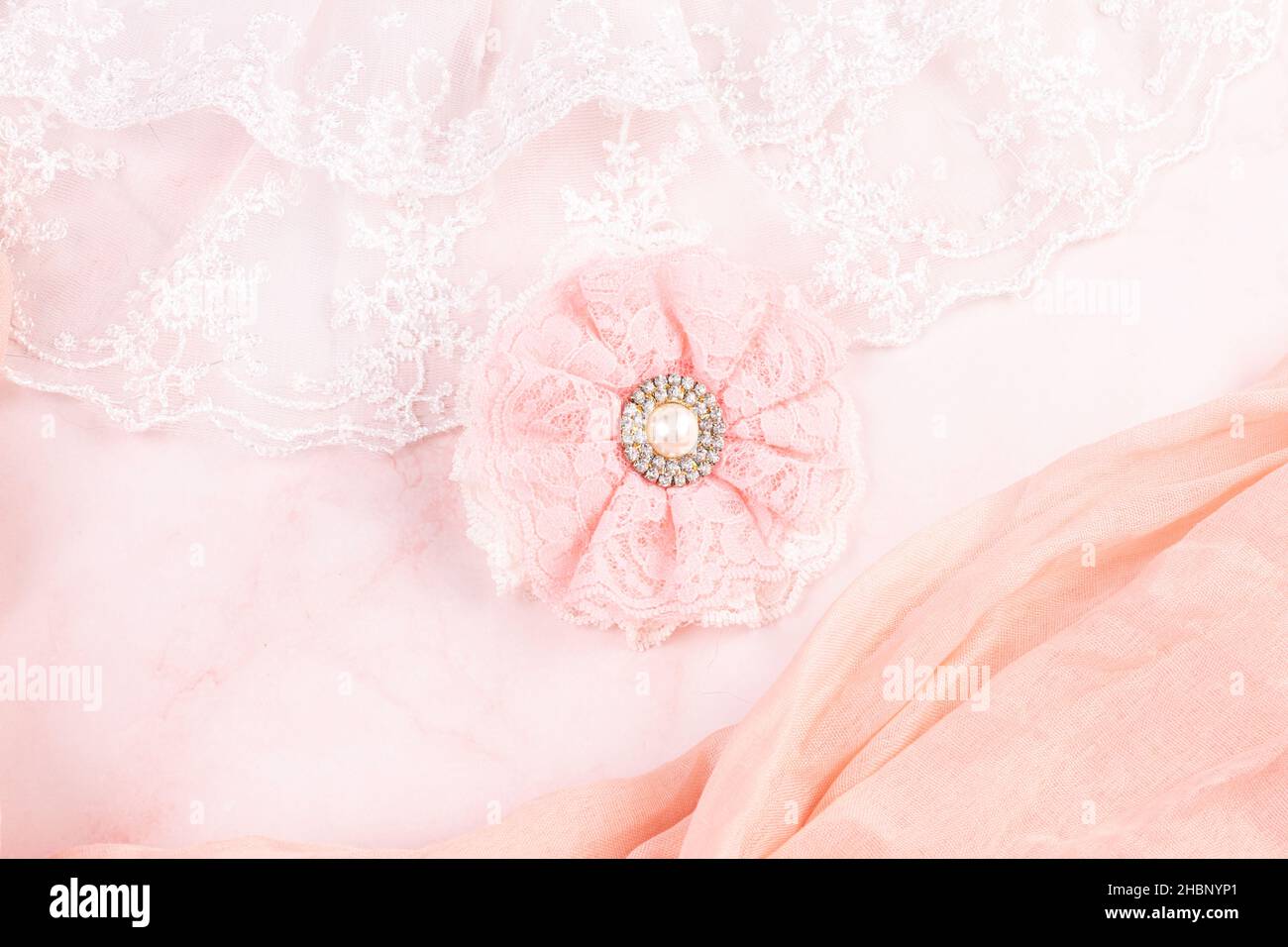 Pink lace flower with a pearl on a pink background Stock Photo - Alamy