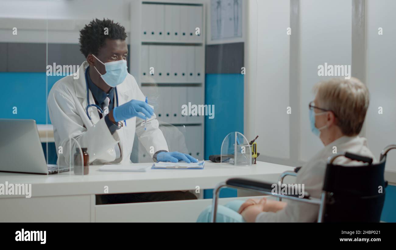 Invalid old patient with handicap at checkup appointment with man ...