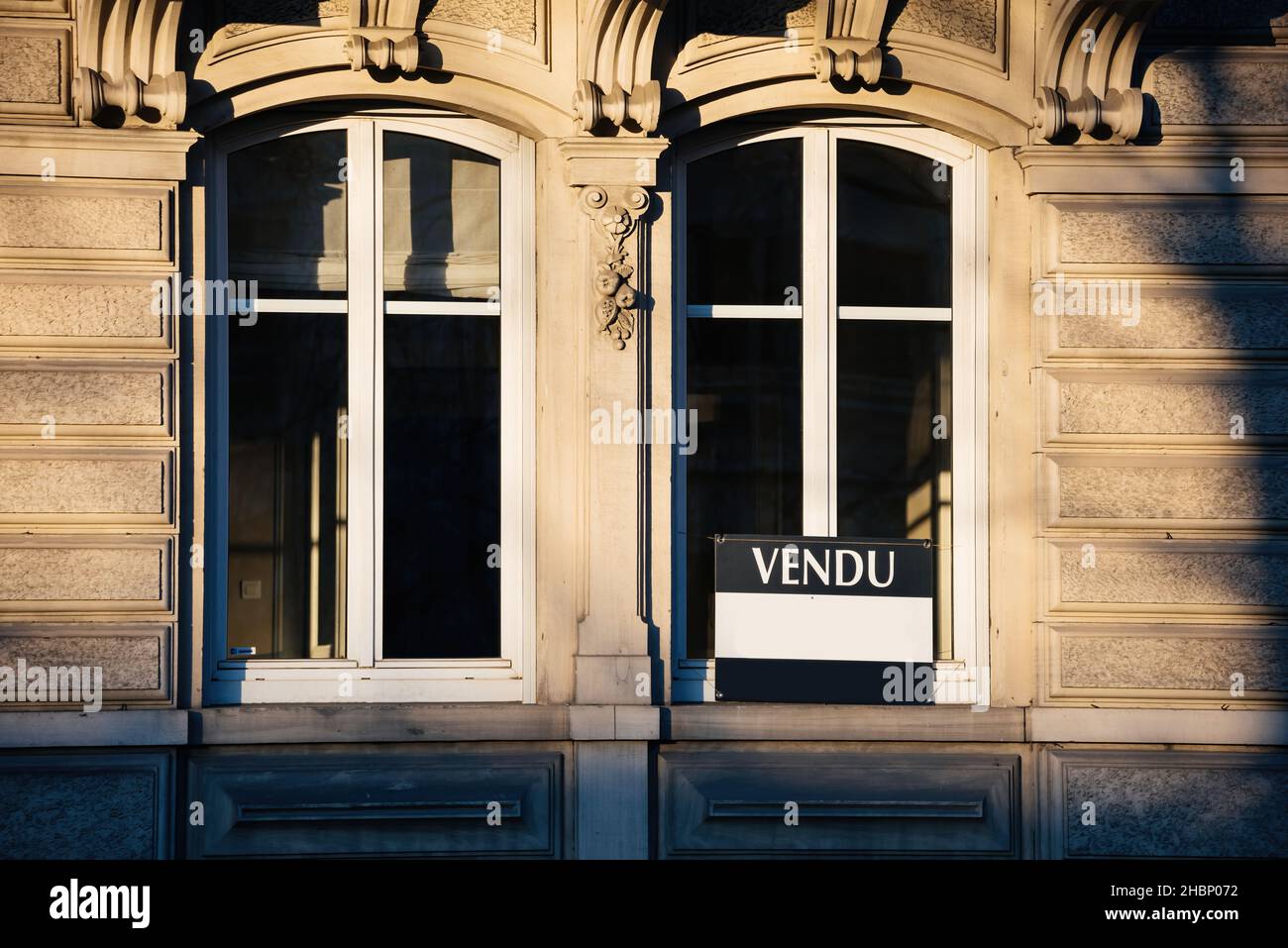 Vendu sign advertising translated as Sold from French on the window of ...