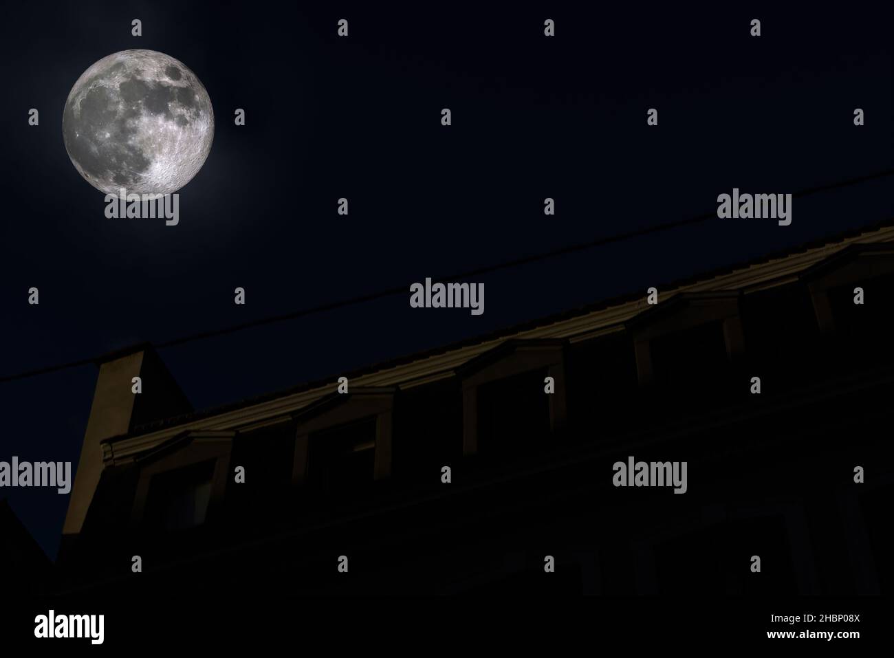 Full moon above the rooftop of French apartment building at night Stock ...
