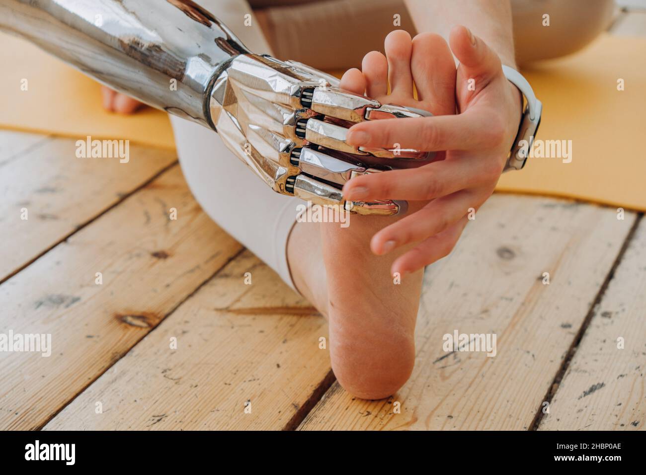 Cheerful woman with metal bionic prosthesis arm does stretching ...