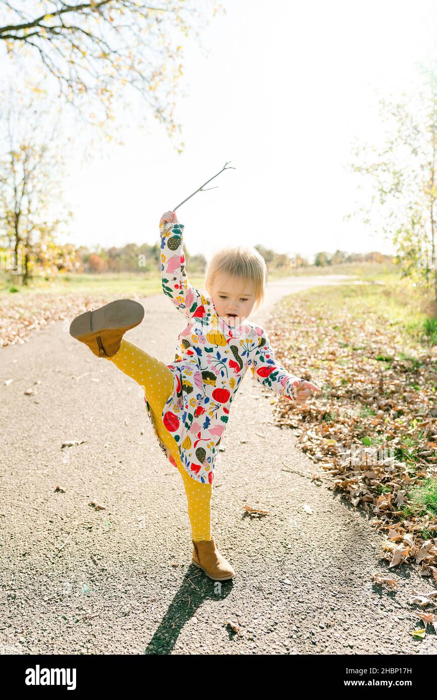 Full length portrait of a toddler balancing on one feet Stock Photo - Alamy