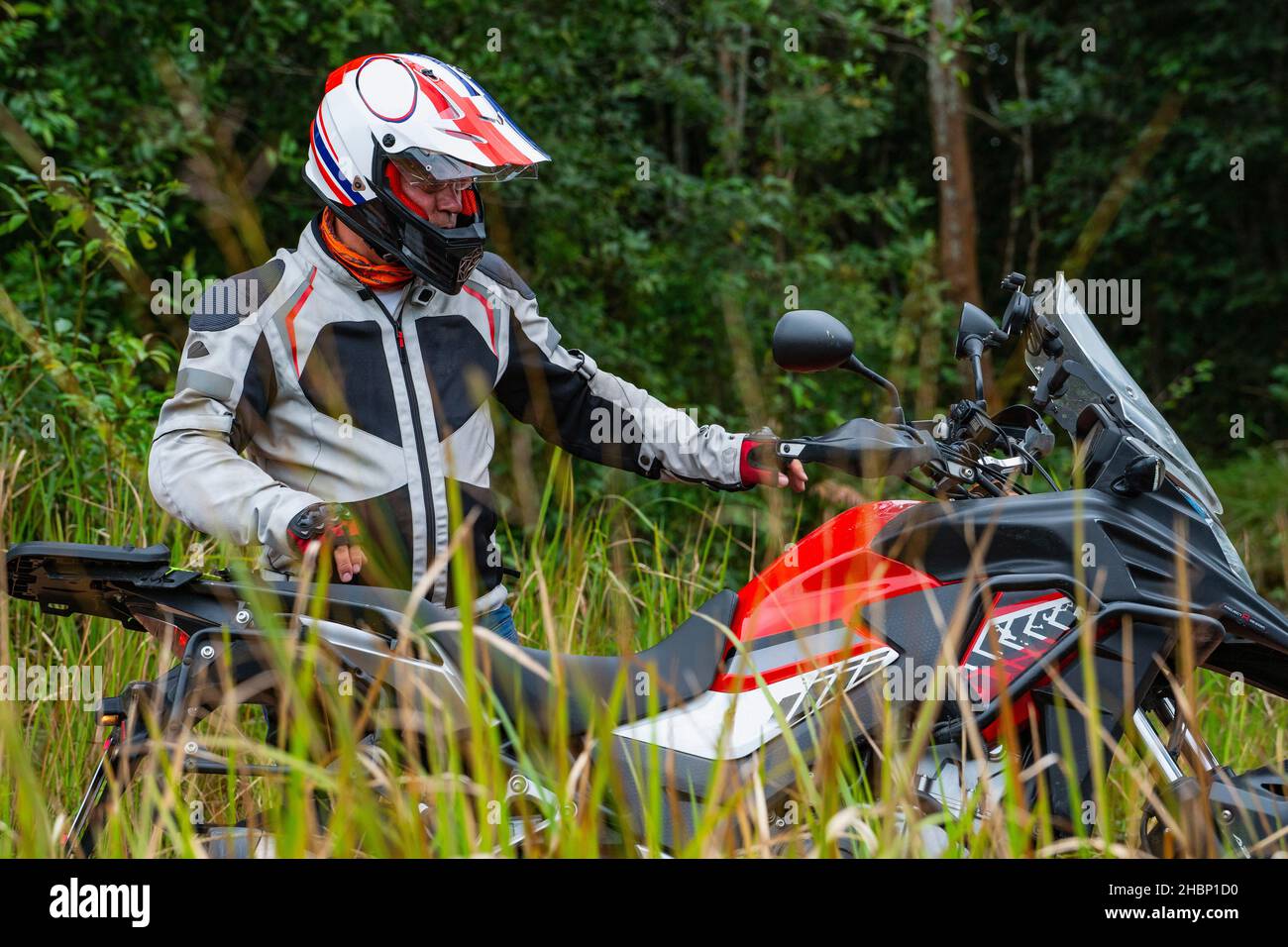 man getting ready to ride his motorcycle in Khao Yai national park ...