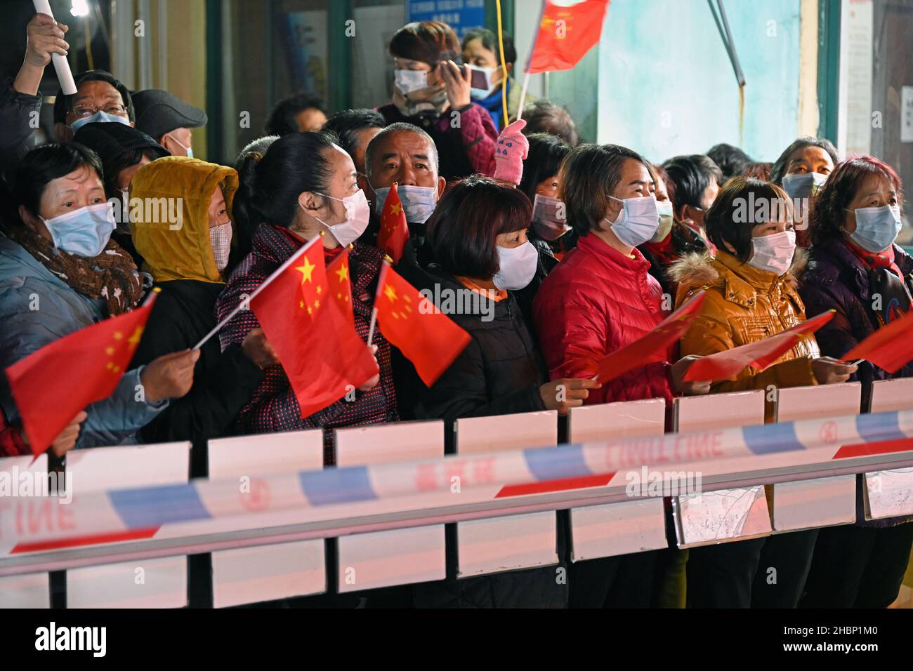 SHANGHAI, CHINA - DECEMBER 20, 2021 - Residents wait at the gate of ...