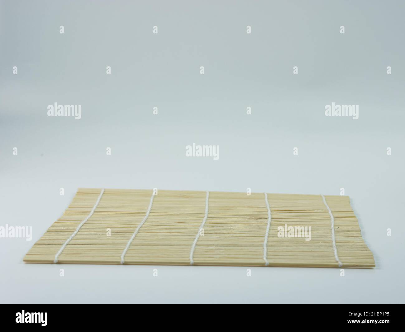 sushi rolling mat bamboo isolated on white background Stock Photo - Alamy