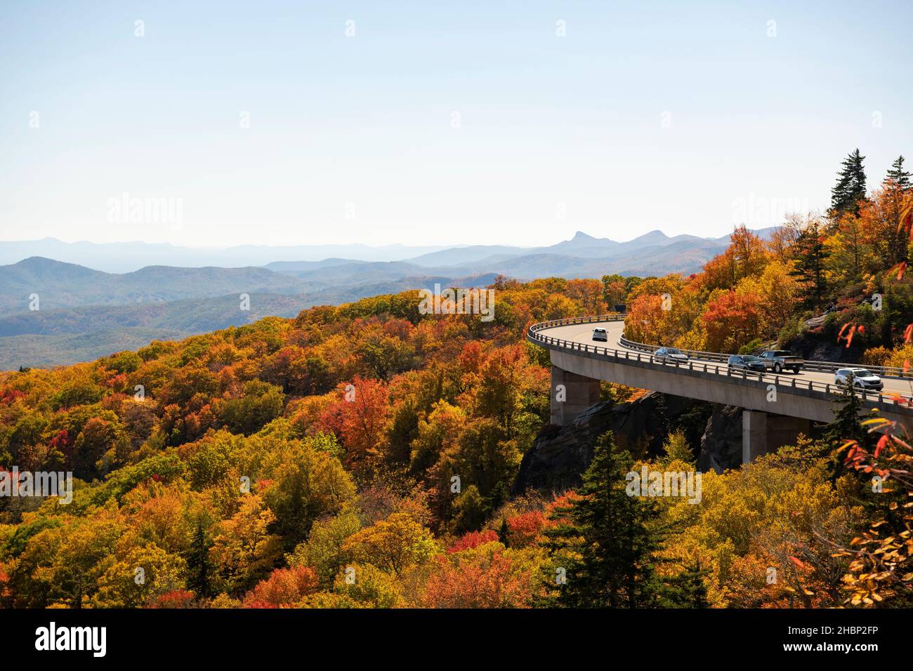 Cars on bridge over autumn trees against clear sky Stock Photo - Alamy