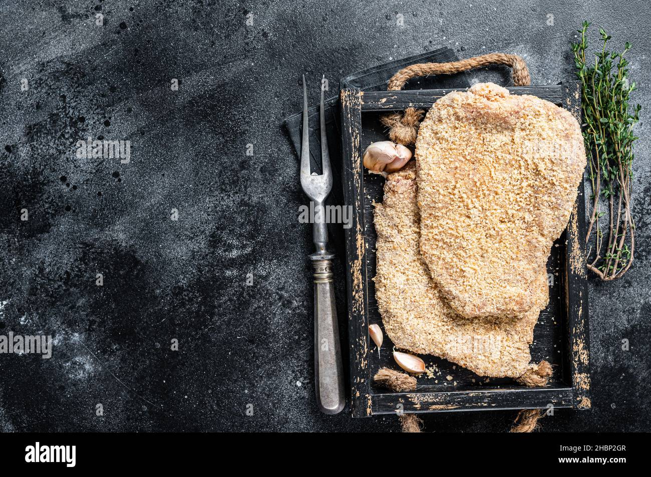 Homemade German Wiener Raw schnitzel in a wooden tray. Black background ...