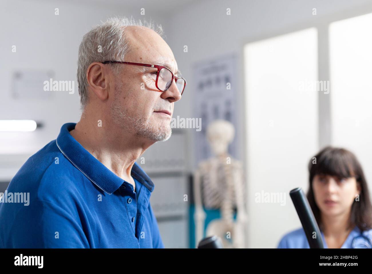 Close up of aged patient using gear for physical exercise and recovery ...
