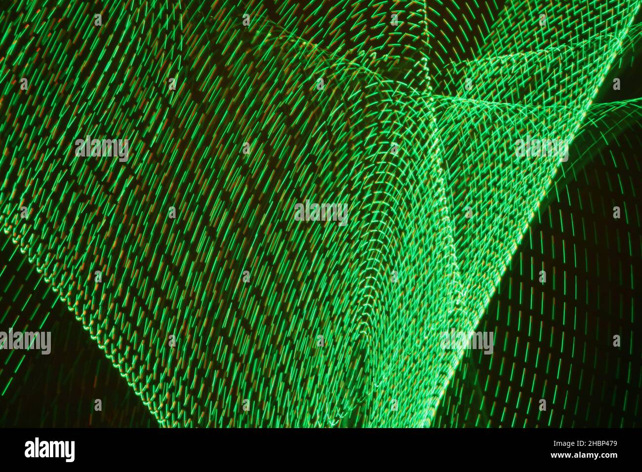 An abstract moving green neon light for techno wallpaper or background ...