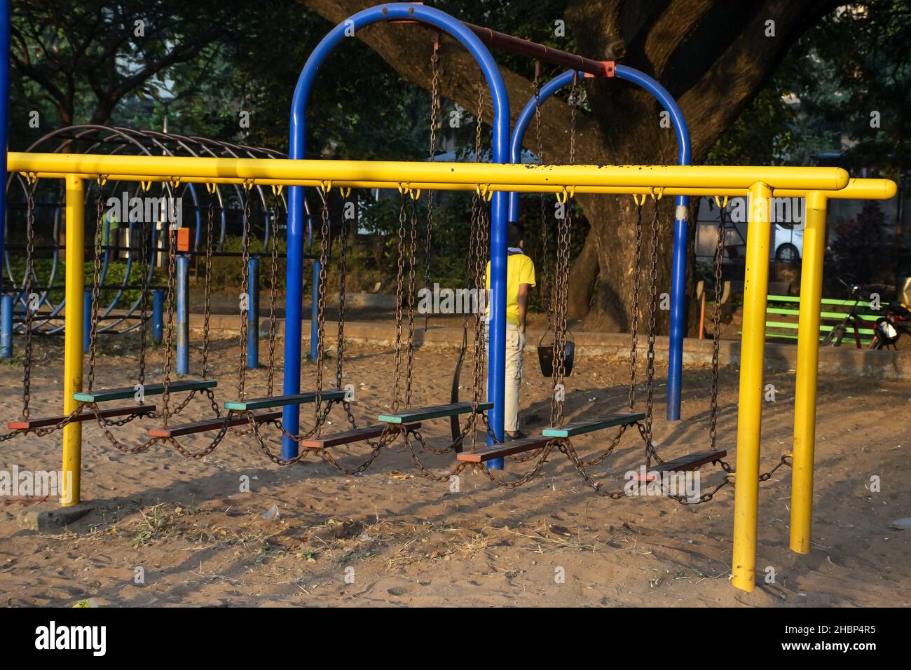 The yellow and blue playground equipment in a park in Kolhapur ...