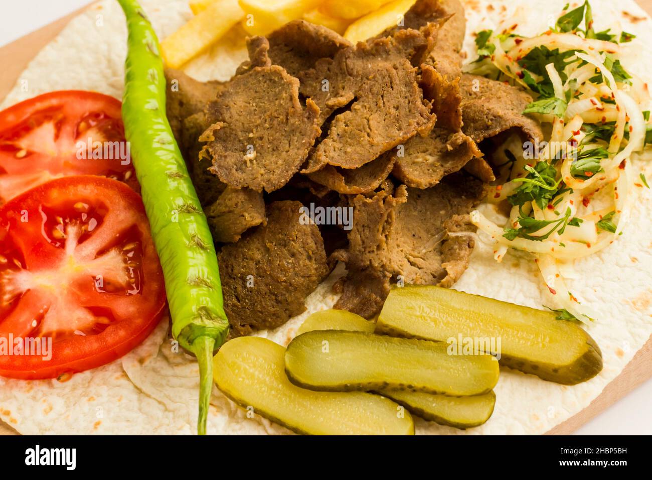 Traditional Turkish kebab doner with sliced tomatoes,grilled vegetables ...