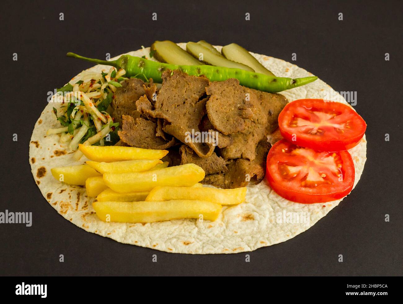 Traditional Turkish kebab doner ,served on flat,sheet bread with tomato ...