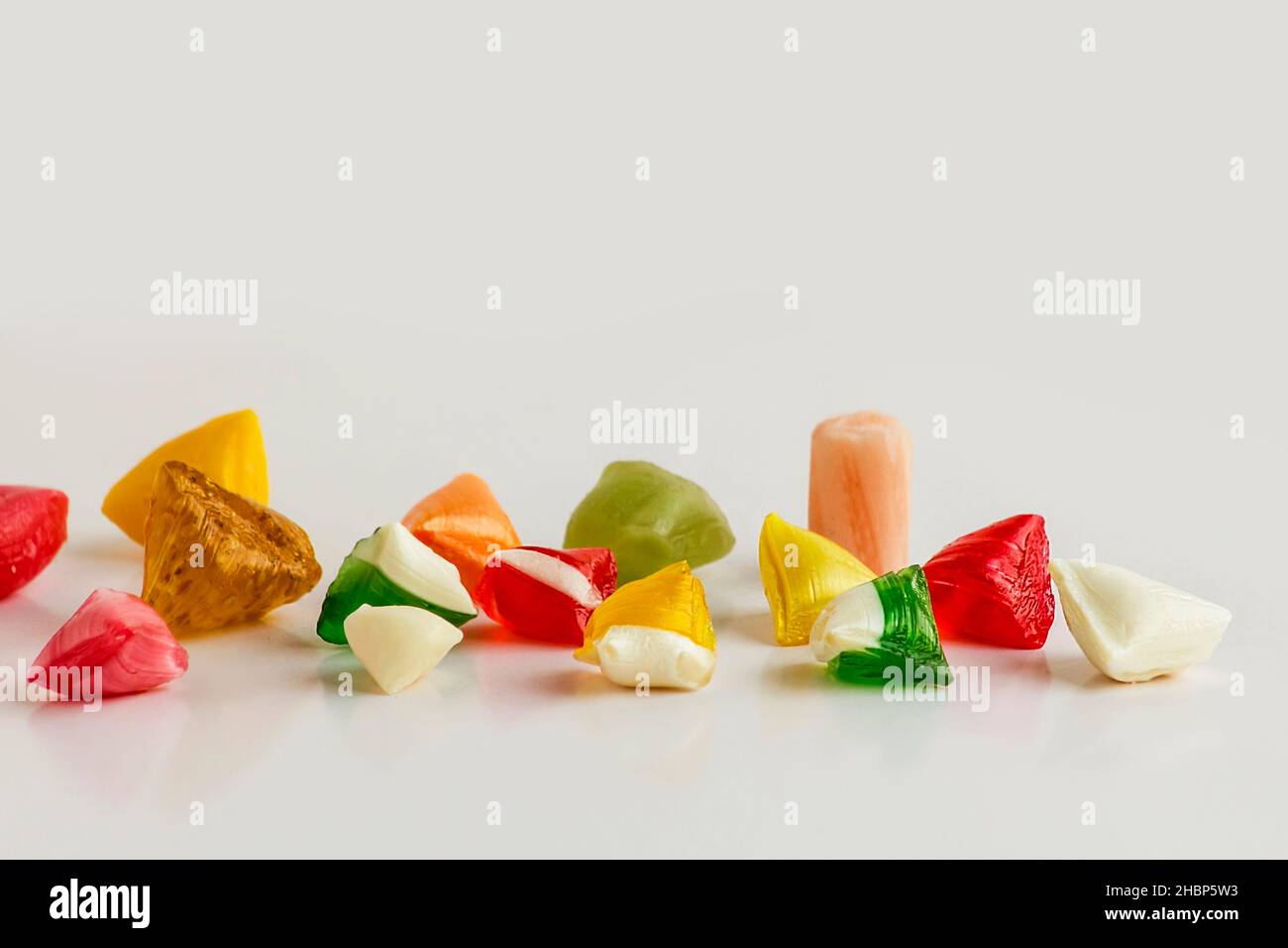 Traditional Turkish hard candy Akide in line on white surface with copy ...