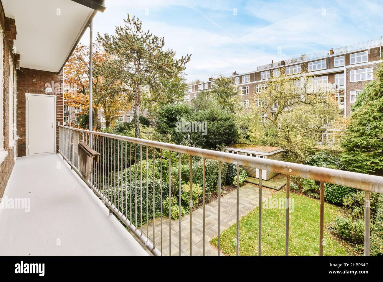 Handsome long narrow balcony with metal railings Stock Photo - Alamy