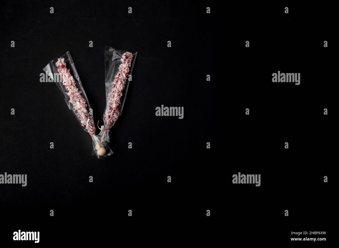 Crushed candy cane sticks isolated in the black background with a copy ...