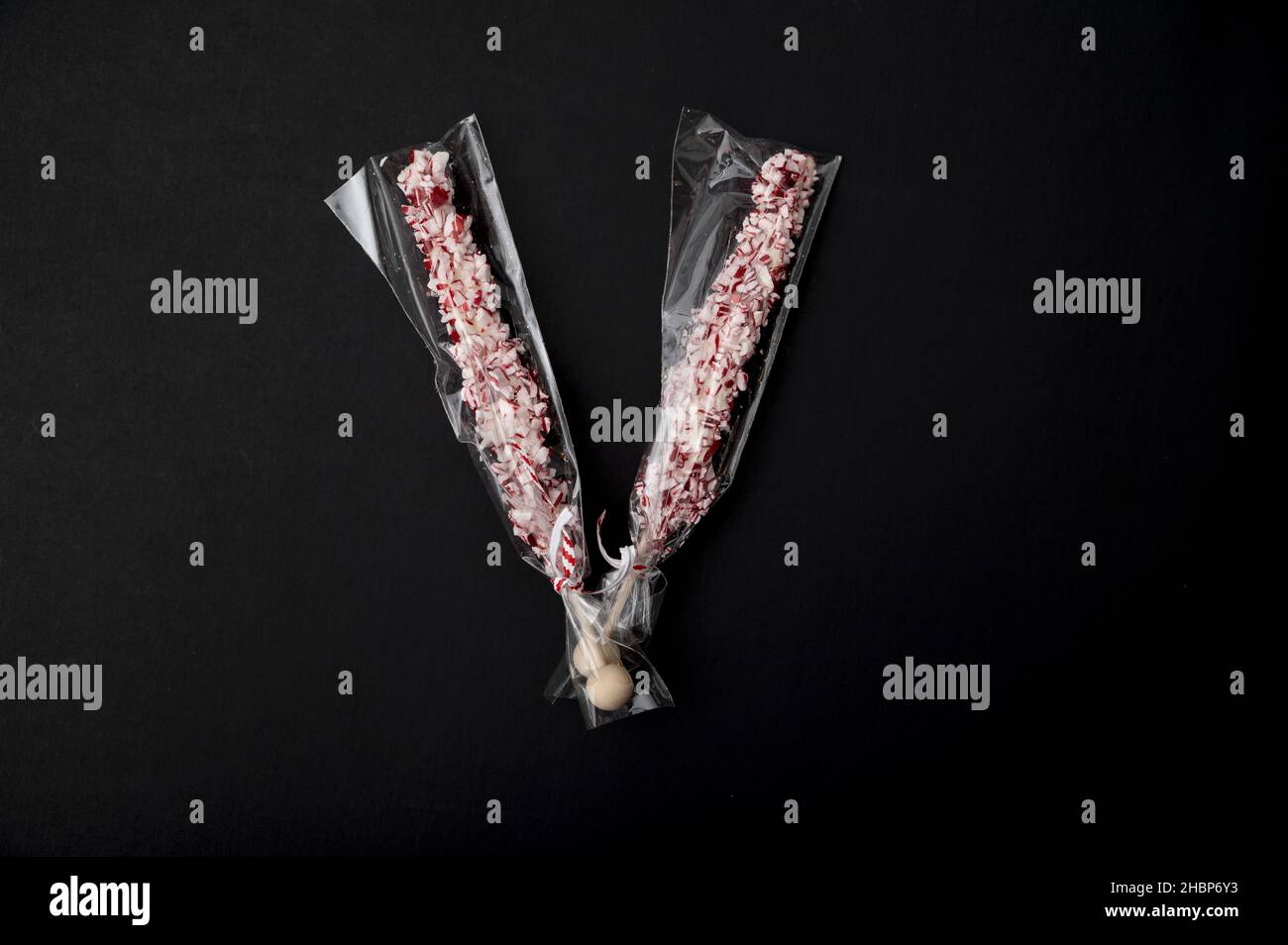 Two crushed candy cane sticks isolated in the black background Stock ...