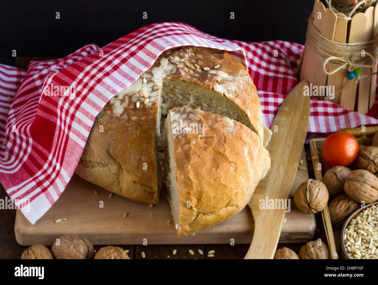 Fresh,Sourdough,Rustic Round Bread sliced on the wooden table with red ...